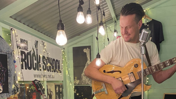 This enterprising papa runs Zoom music lessons from a cubby house