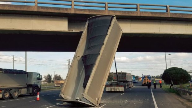 Truck comes off second best after driver hits bridge with raised trailer