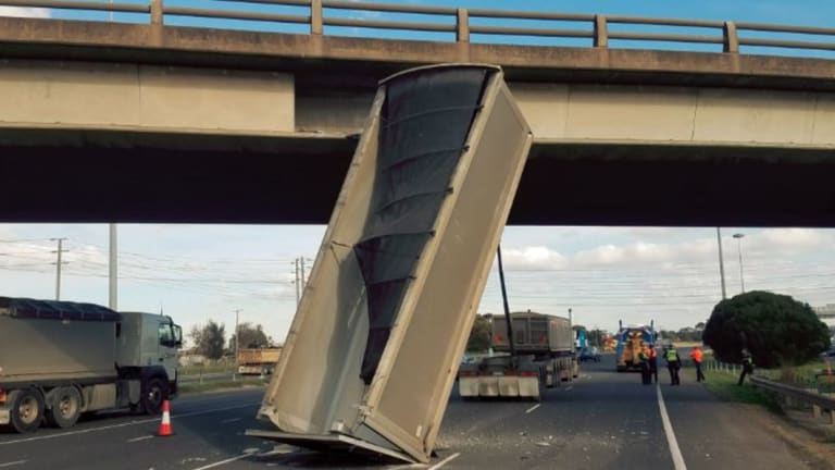 Truck comes off second best after driver hits bridge with raised trailer