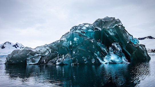 Photographer captures rare shot of flipped iceberg's underbelly