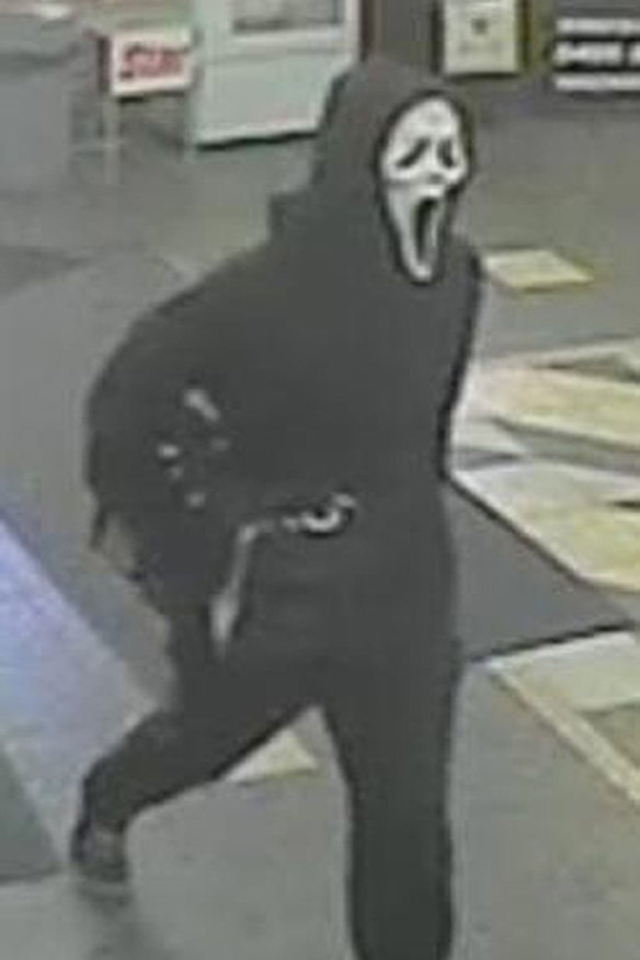 'Scream' mask robber threatens woman