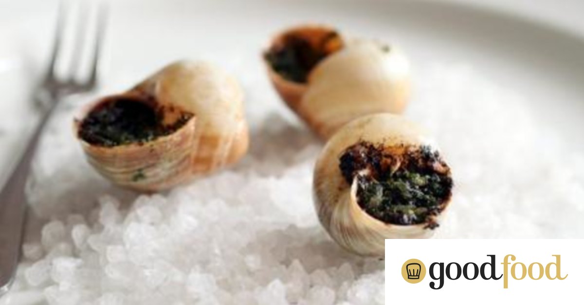 What causes the skin to form on heated milk?