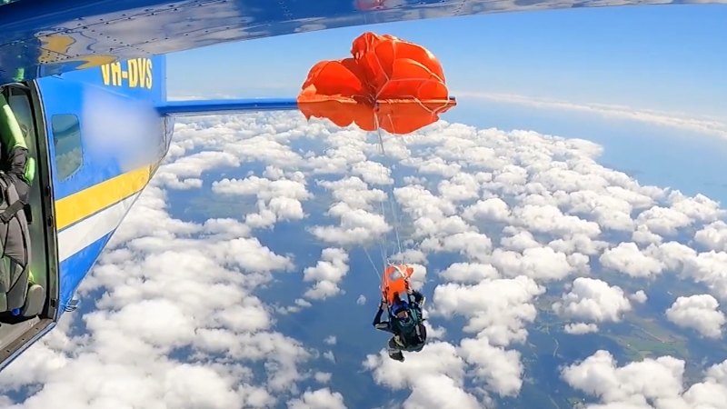 Parachuter gets caught on tail of plane