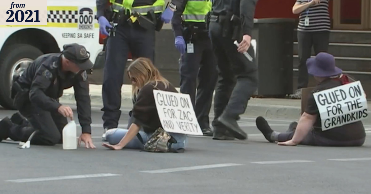Climate change protesters glue themselves to city streets