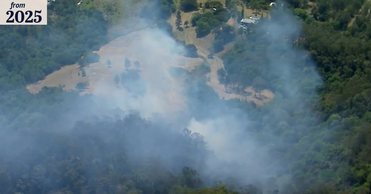 Slow-moving fire threatening properties in Brisbane's north-west